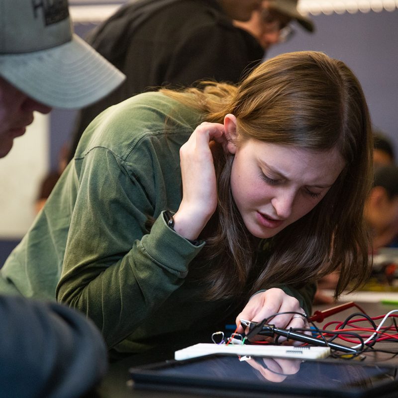 Female student works with circuit board in a Min H. Kao Engineering ...